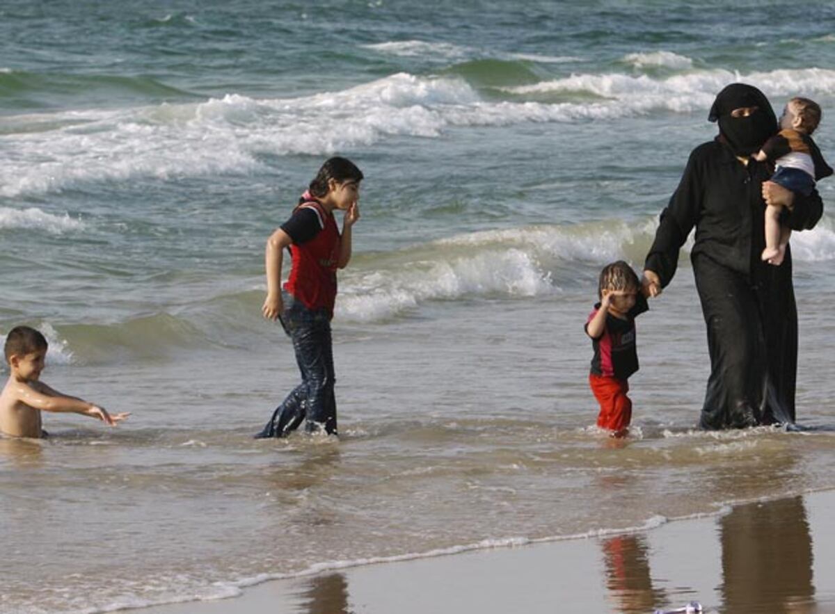 Una palestina pasea cubierta por la playa en Gaza | Internacional | EL PAÍS